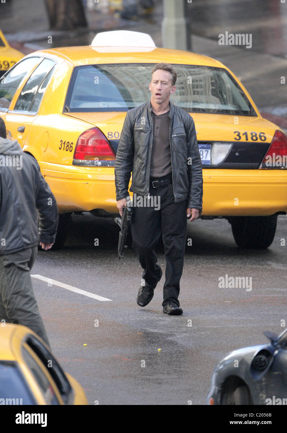 Actors stage a gun fight in the rain filming a scene for 'Inception ...