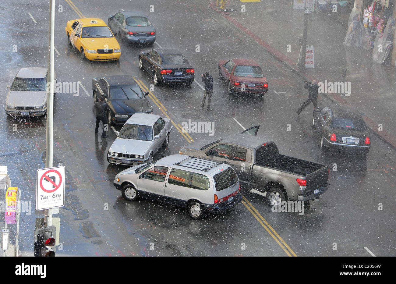 Actors stage a gun fight in the rain filming a scene for 'Inception ...