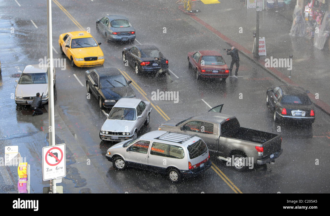 Actors stage a gun fight in the rain filming a scene for 'Inception ...