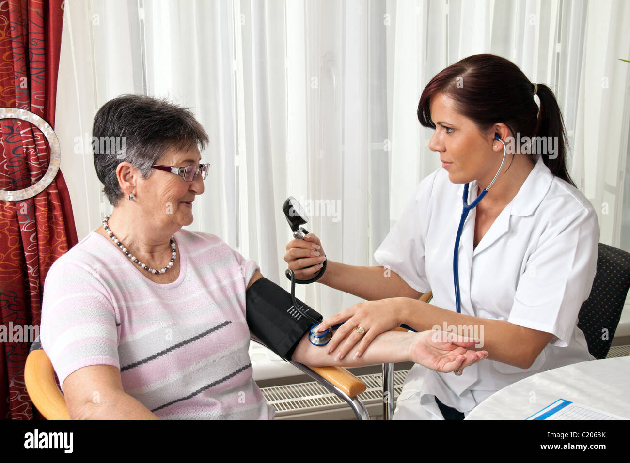 Doctor measuring blood pressure Stock Photo - Alamy Doctor measuring blood pressure Stock Photo - Alamy