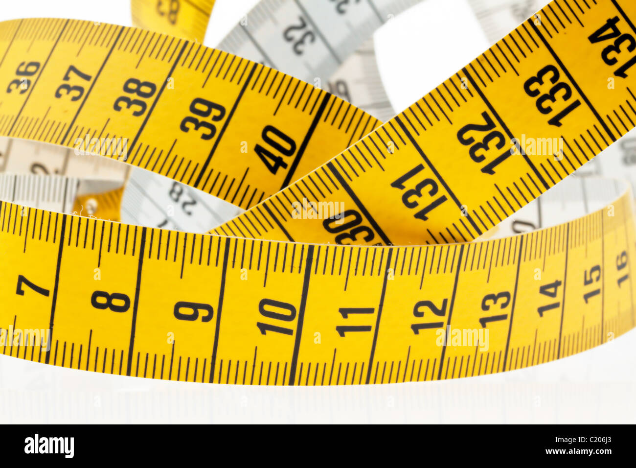 Measuring tape on white background Stock Photo - Alamy