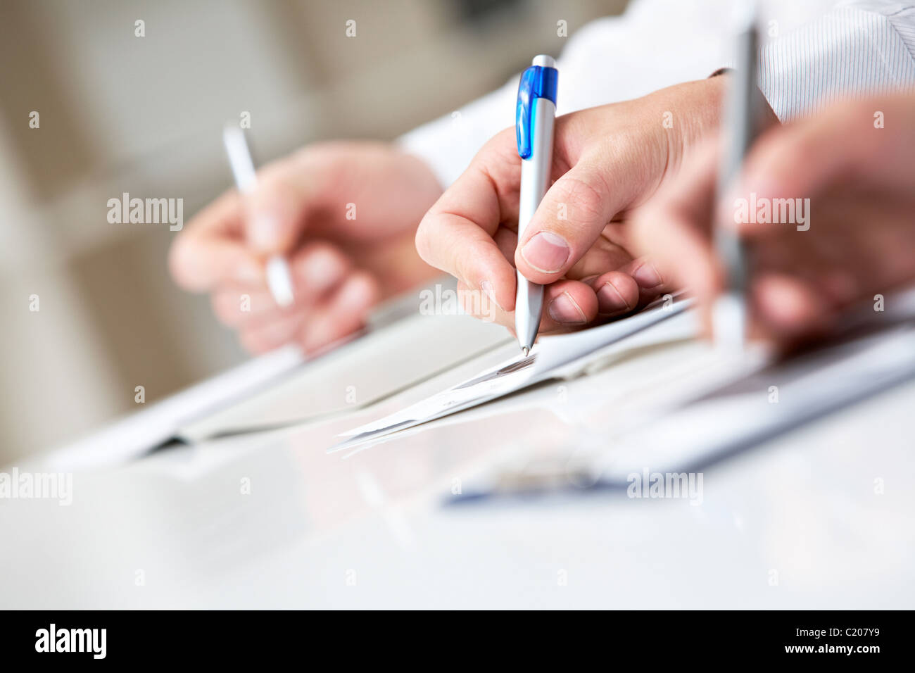 Image of row of people hands writing on papers at seminar Stock Photo ...