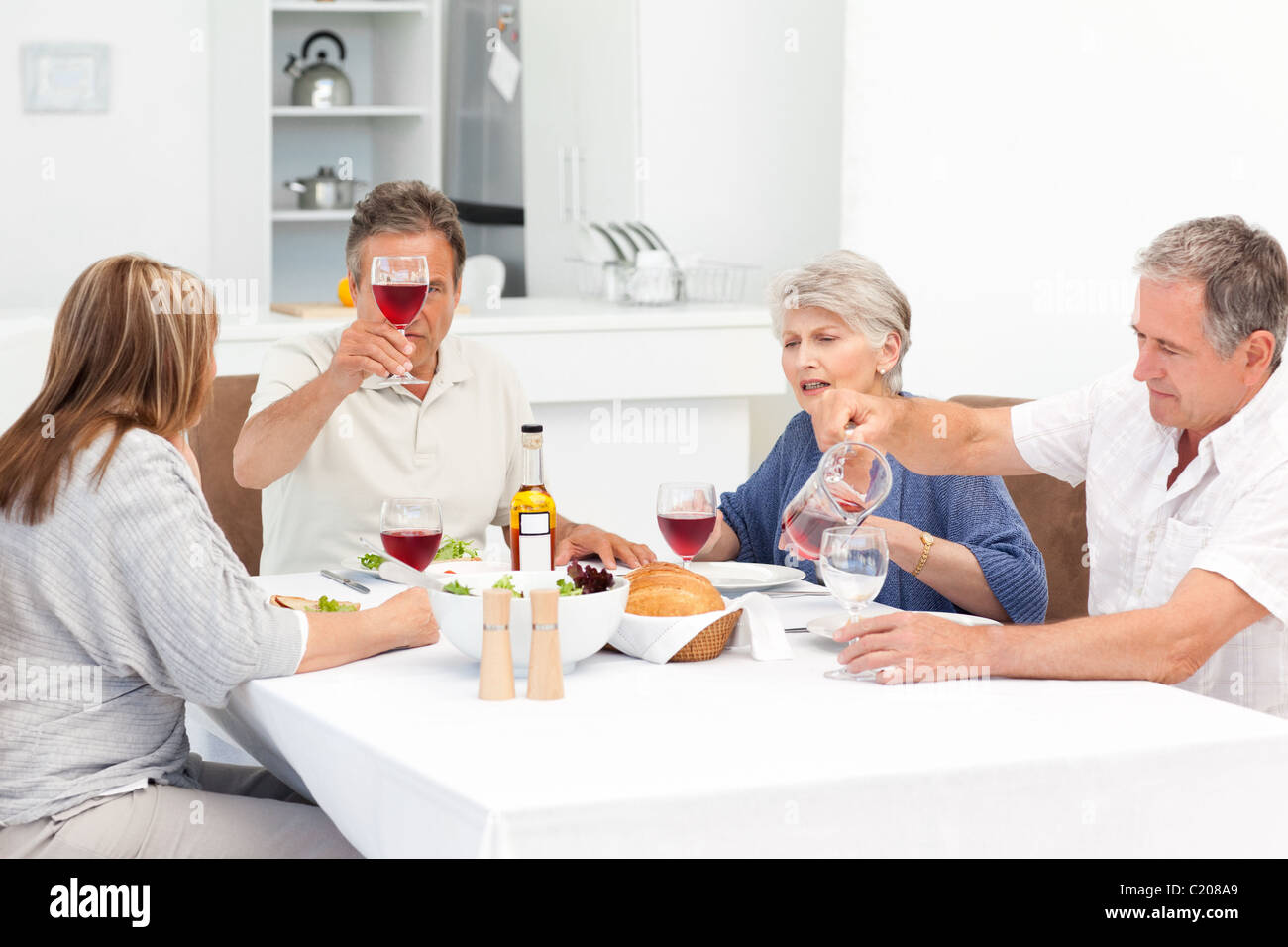 Mature friends taking lunch together Stock Photo - Alamy