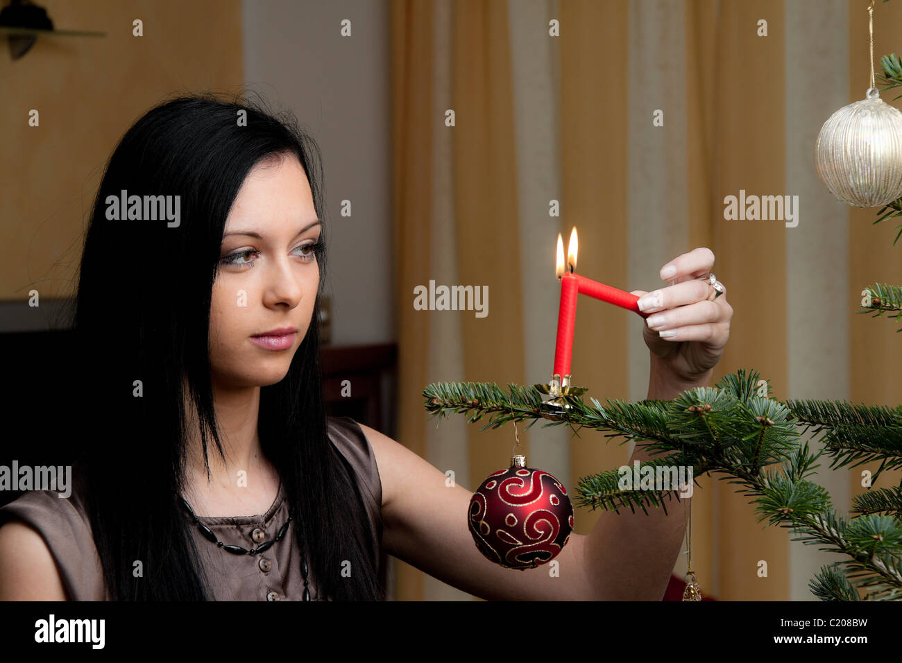 Young woman with Christmas tree at Christmas Stock Photo - Alamy