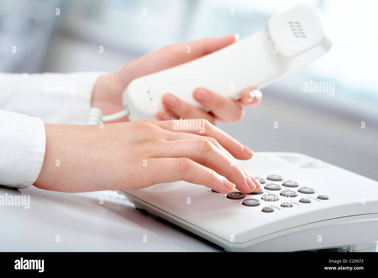 Close-up of receptionist making a phone call Stock Photo - Alamy