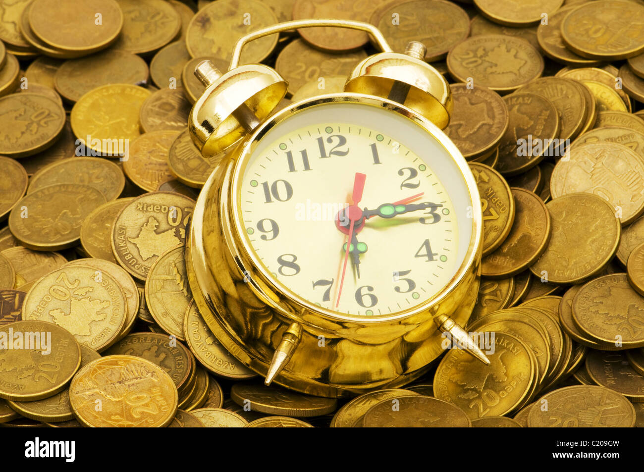 Time is money concept with clock and coins Stock Photo - Alamy
