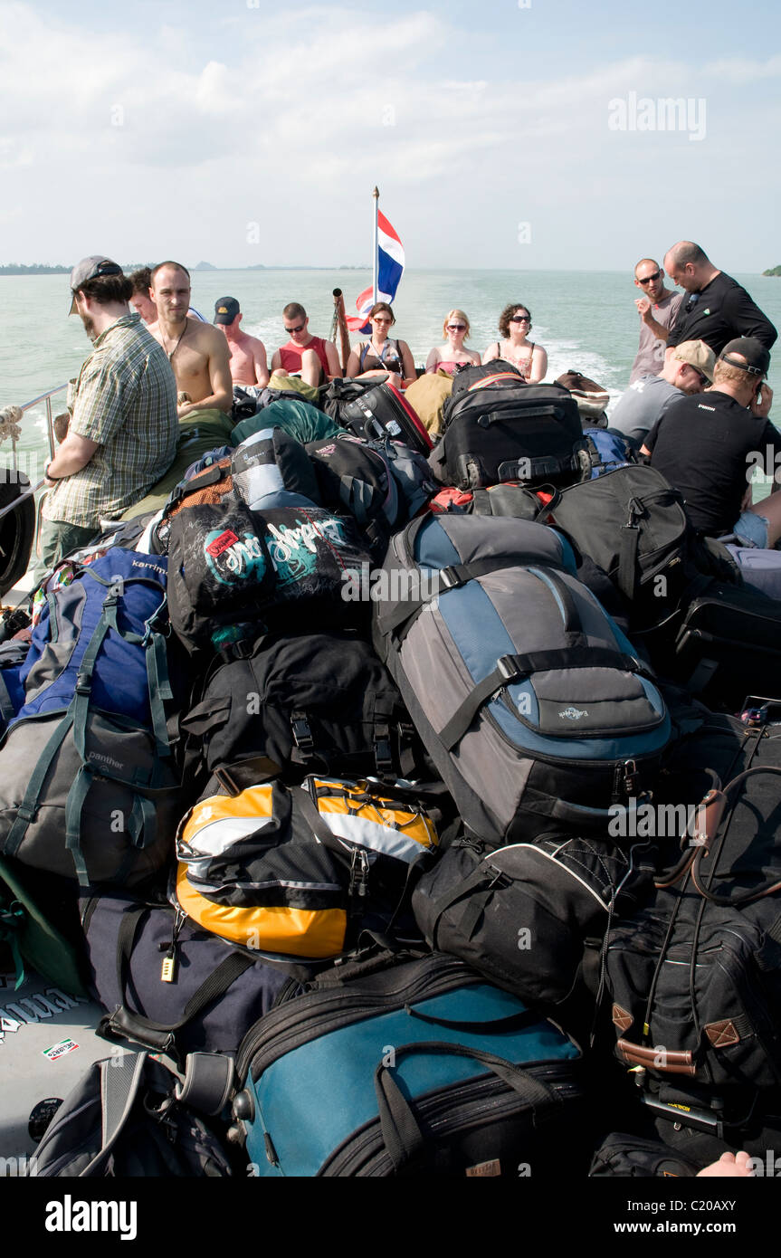 Backpackers and tourists on a boat travelling to islands, Thailand ...