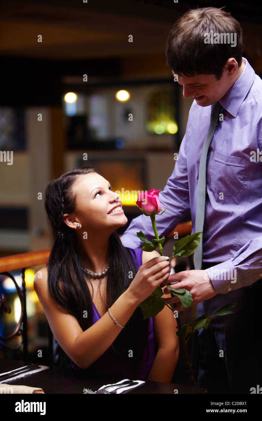Image of man giving a red rose to his girlfriend Stock Photo - Alamy