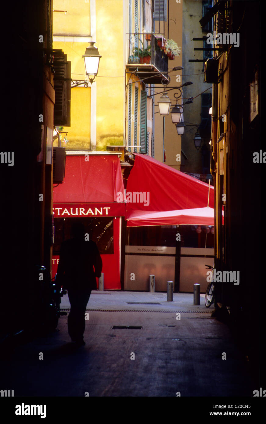 dark narrow street in the old town of Nice Stock Photo - Alamy