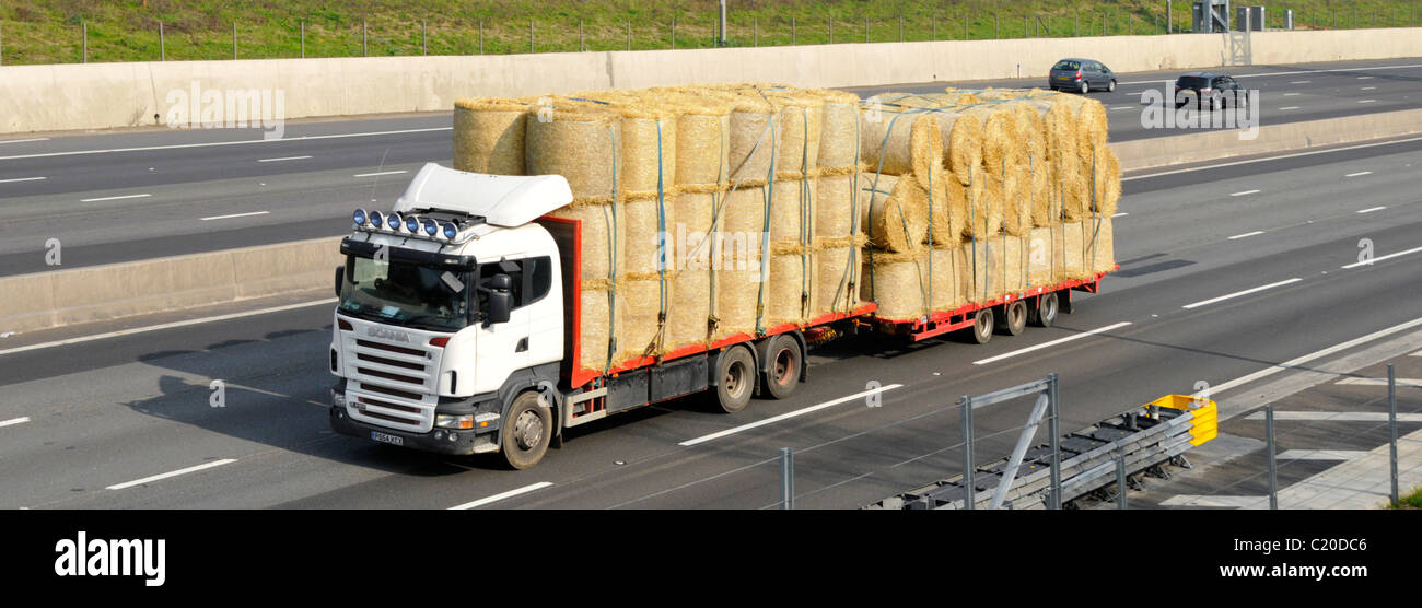 Front & side view of tow trailer & unmarked hgv flatbed lorry truck ...