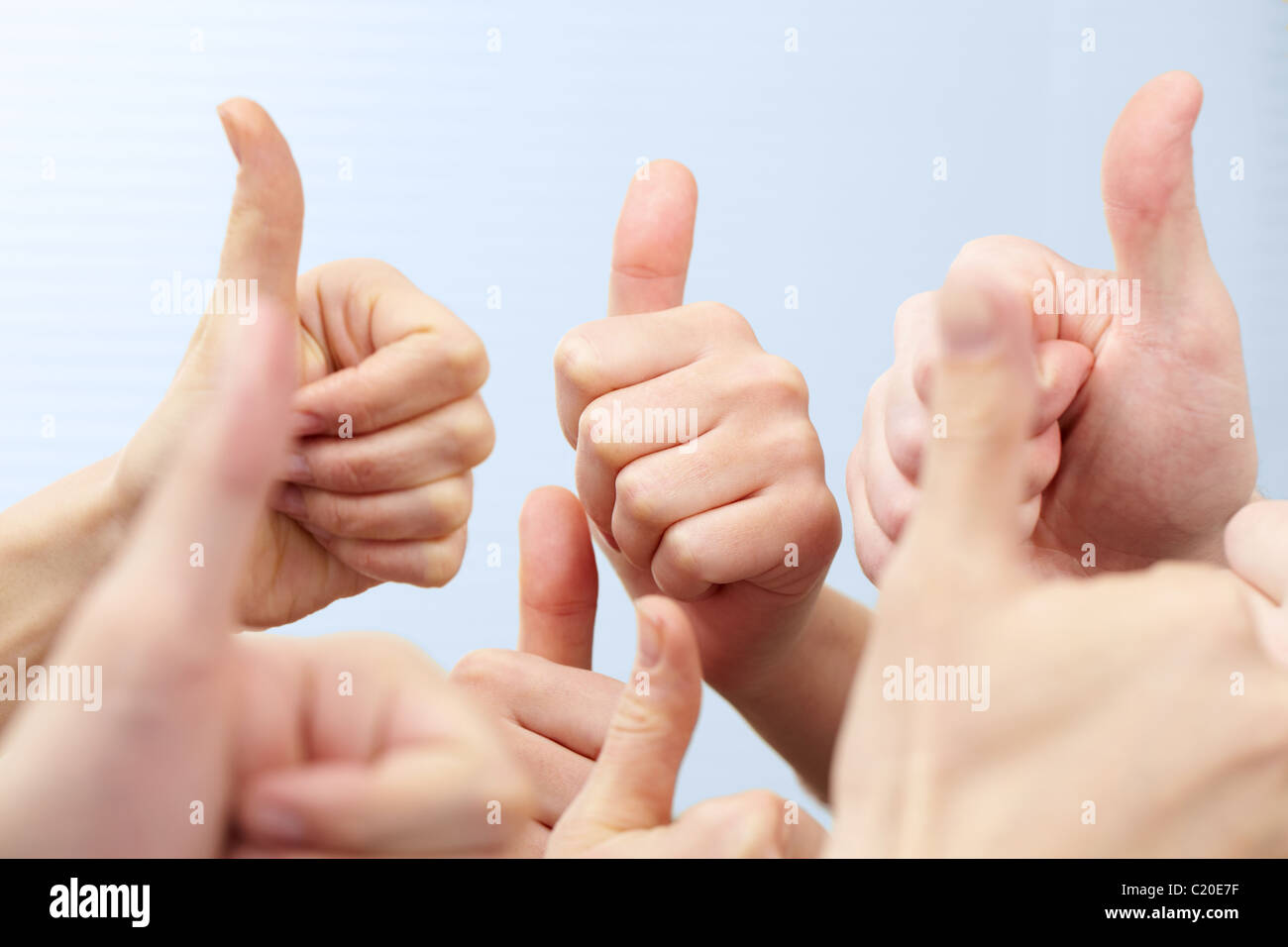 Several hands showing a symbol of success Stock Photo - Alamy