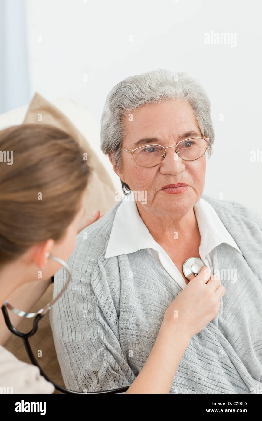 Nurse taking the heartbeat of her patient Stock Photo - Alamy