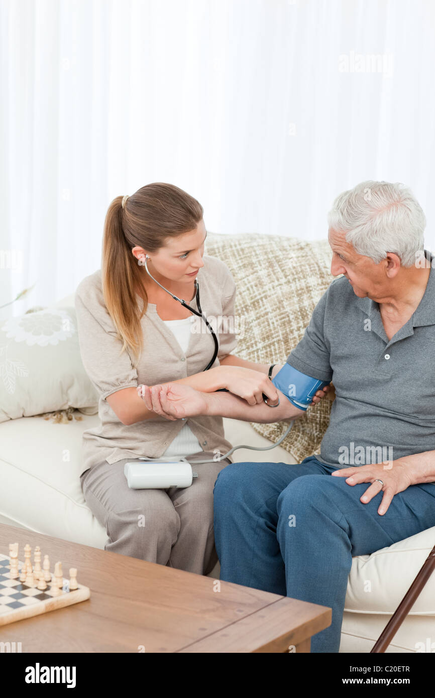 Lovely nurse helping her patient to do exercises Stock Photo - Alamy