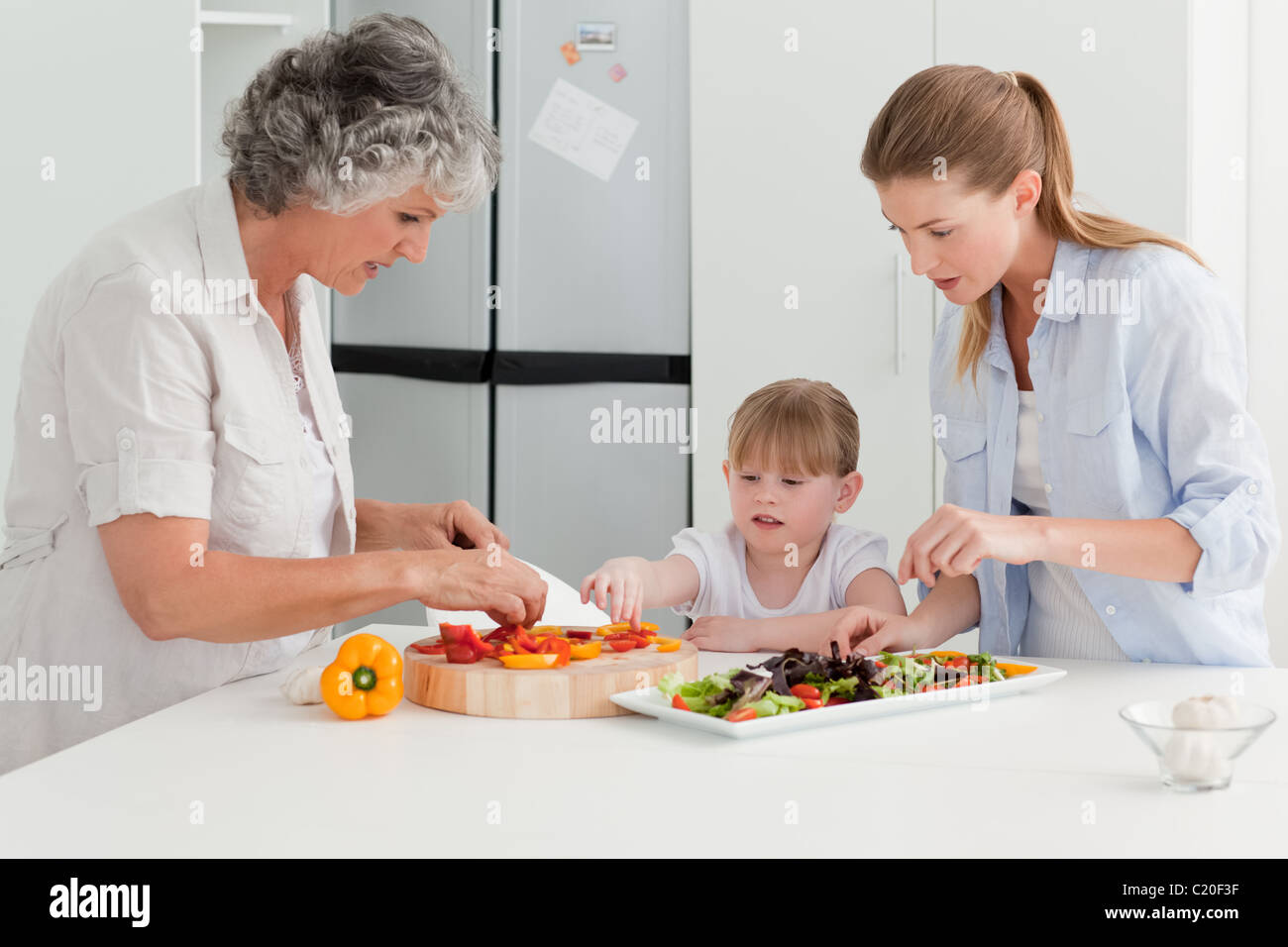 Family cooking together in the kitchen at home Stock Photo - Alamy
