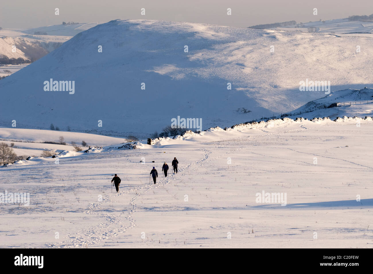 Hiking in the snow on Ecton Hill Peak District UK Stock Photo - Alamy