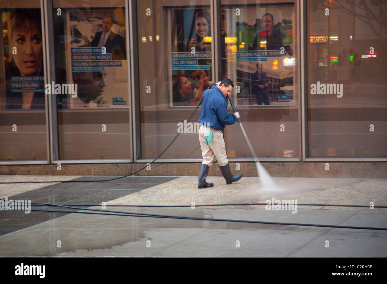 man washing down sidewalk in New York City Stock Photo - Alamy
