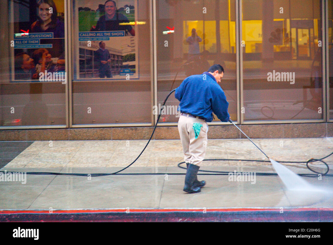 man washing down sidewalk in New York City Stock Photo - Alamy