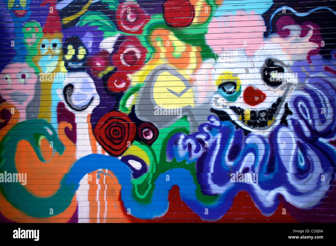Abstraction of graffiti clown image on roll-up door Stock Photo - Alamy