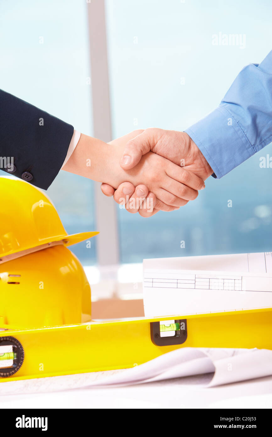 Close-up of workers doing handshake Stock Photo - Alamy