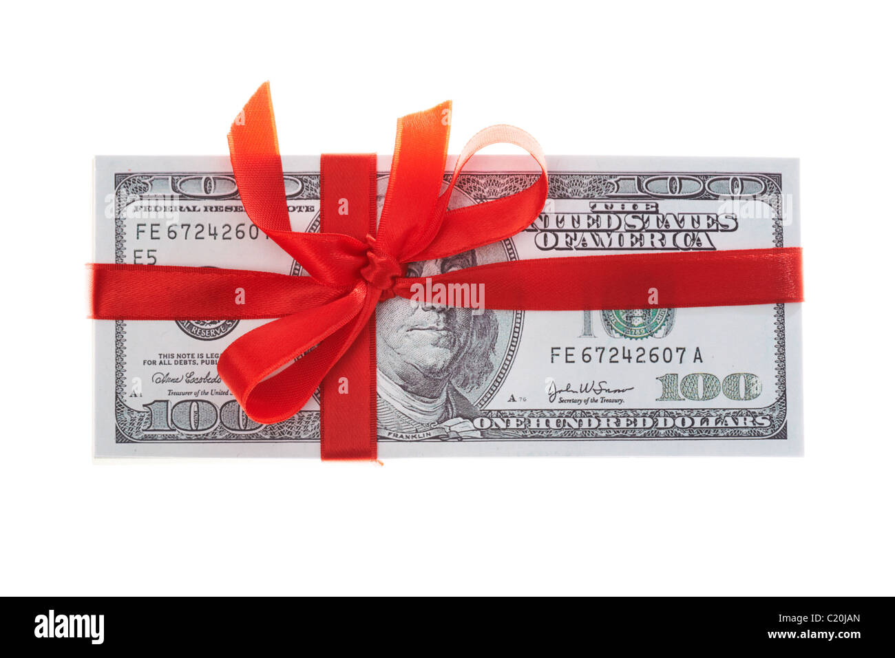 Photo of pack of dollars decorated with red ribbon over white ...