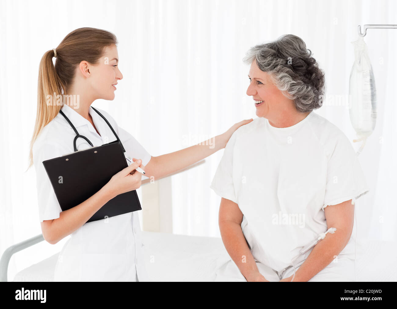 Female nurse talking woman patient hi-res stock photography and images ...