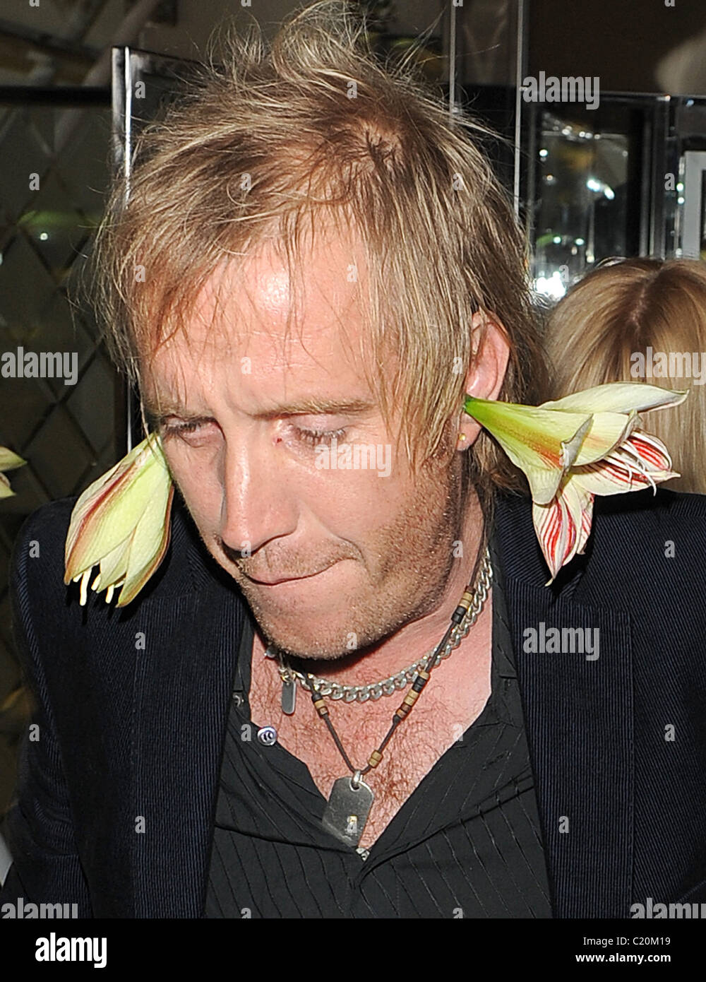 Rhys Ifans leaving the Ivy Club with flowers sticking out of his ears ...