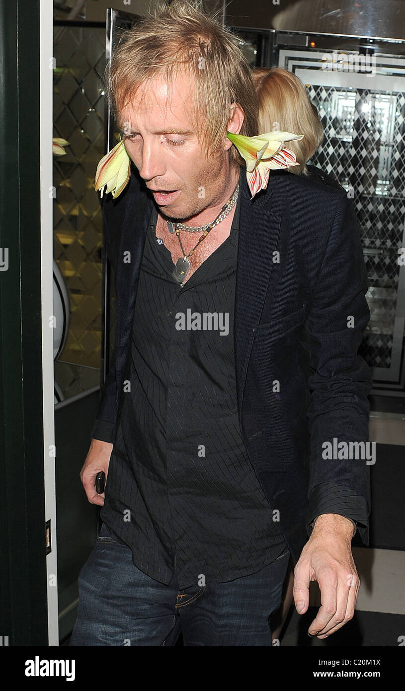 Rhys Ifans leaving the Ivy Club with flowers sticking out of his ears ...