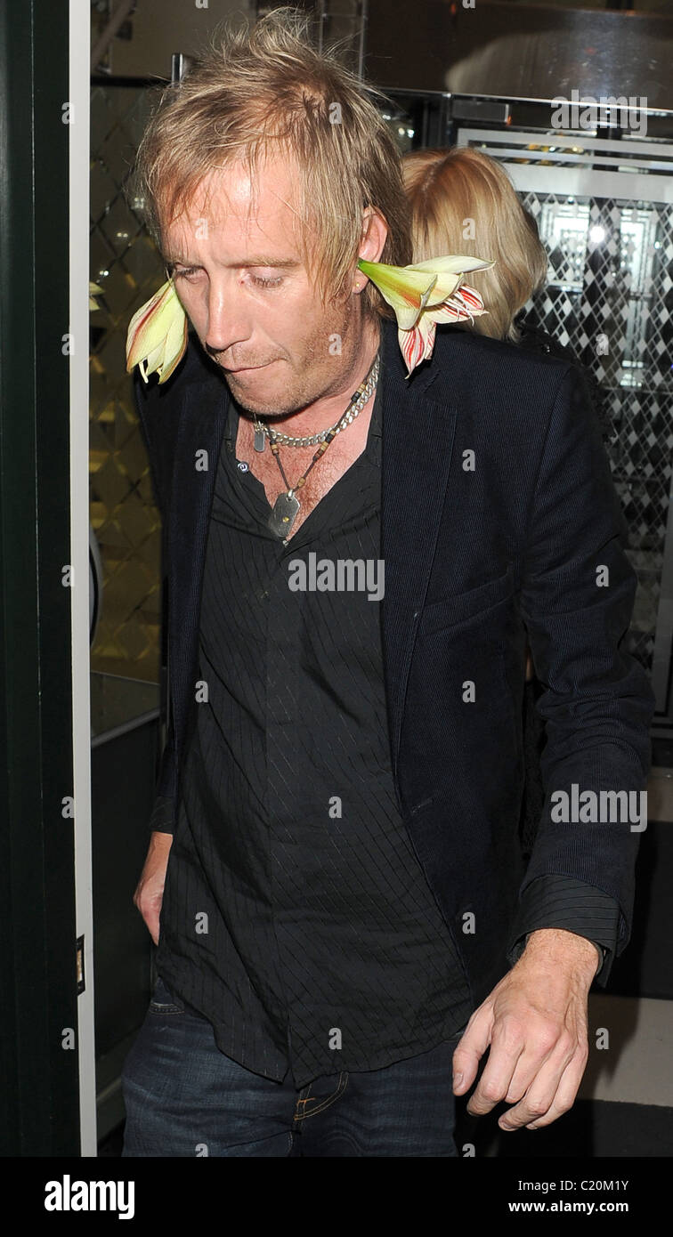 Rhys Ifans leaving the Ivy Club with flowers sticking out of his ears ...