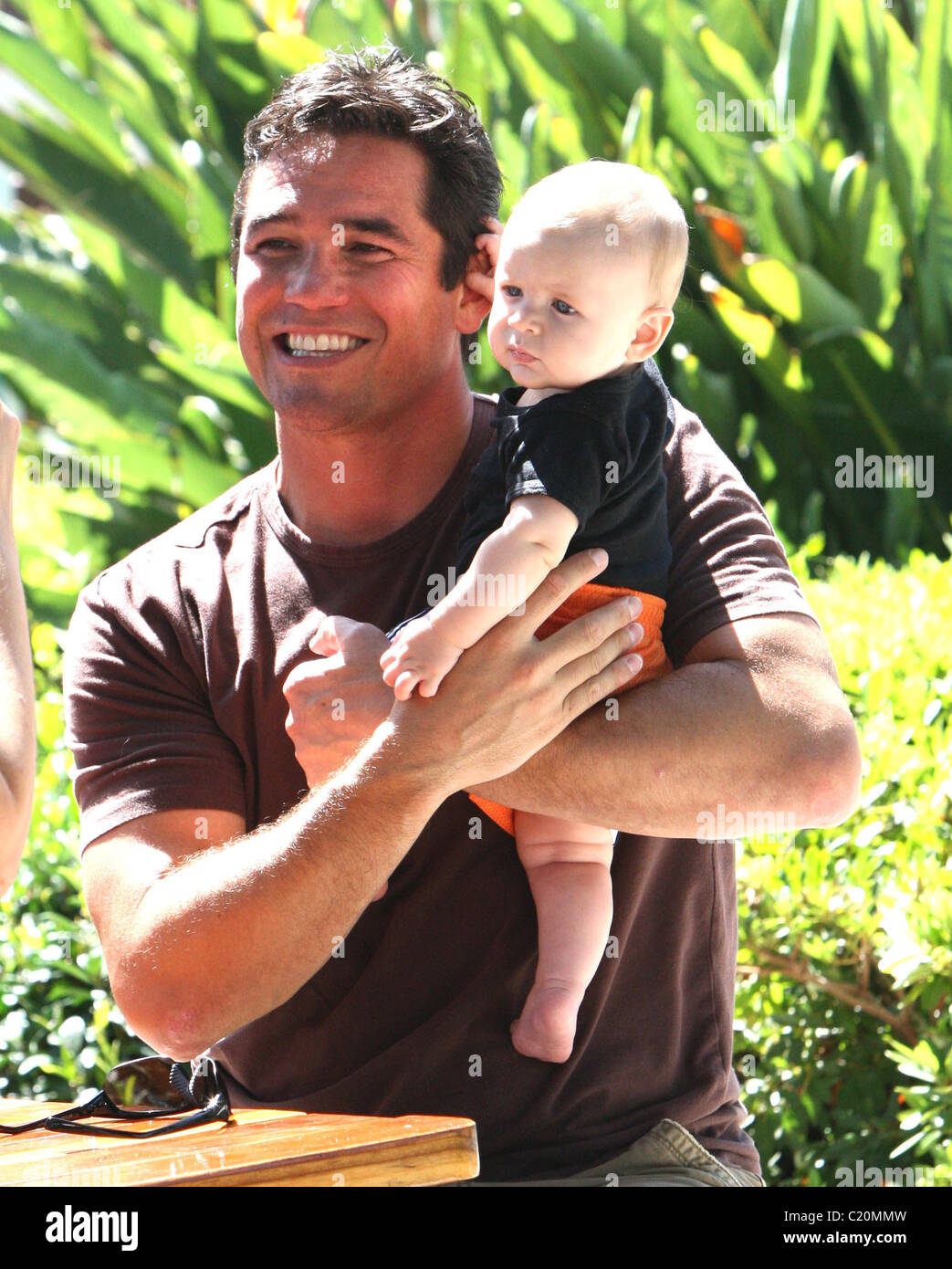 Dean Cain looks after a friend's baby as he visits a restaurant in ...