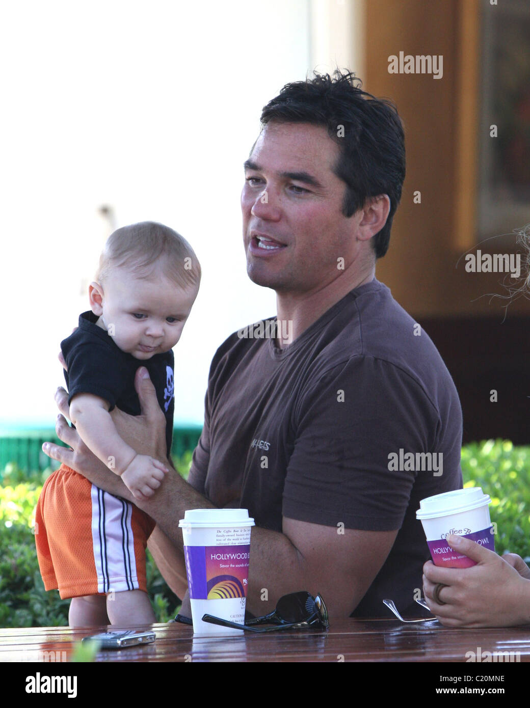 Dean Cain looks after a friend's baby as he visits a restaurant in ...