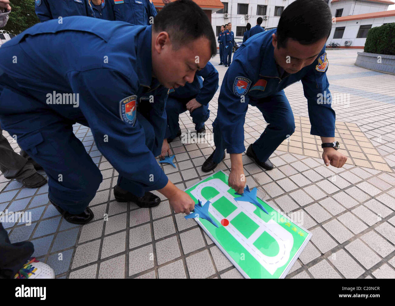 Chinese Air Force fighter pilots use model plans to choreograph an ...