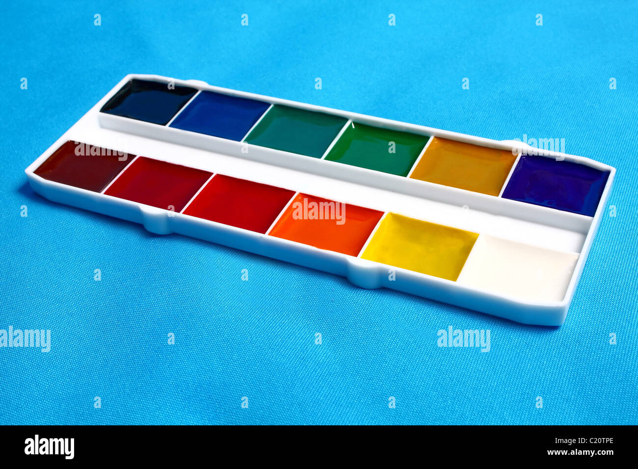 coloured paints for drawing isolated on blue background Stock Photo - Alamy