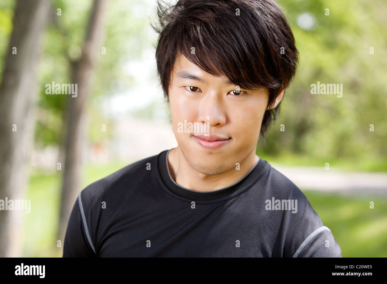 Portrait of a man smiling against blur background Stock Photo - Alamy