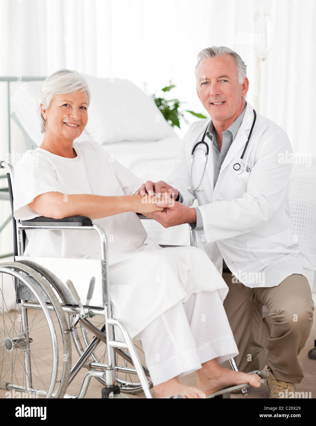 Patient with her doctor looking at the camera Stock Photo - Alamy