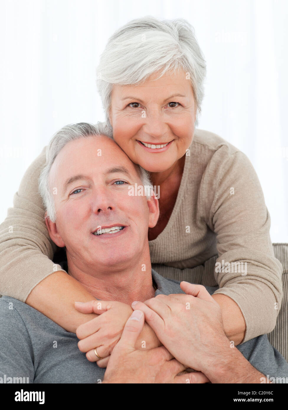Lovers hugging while they are looking at the camera Stock Photo - Alamy
