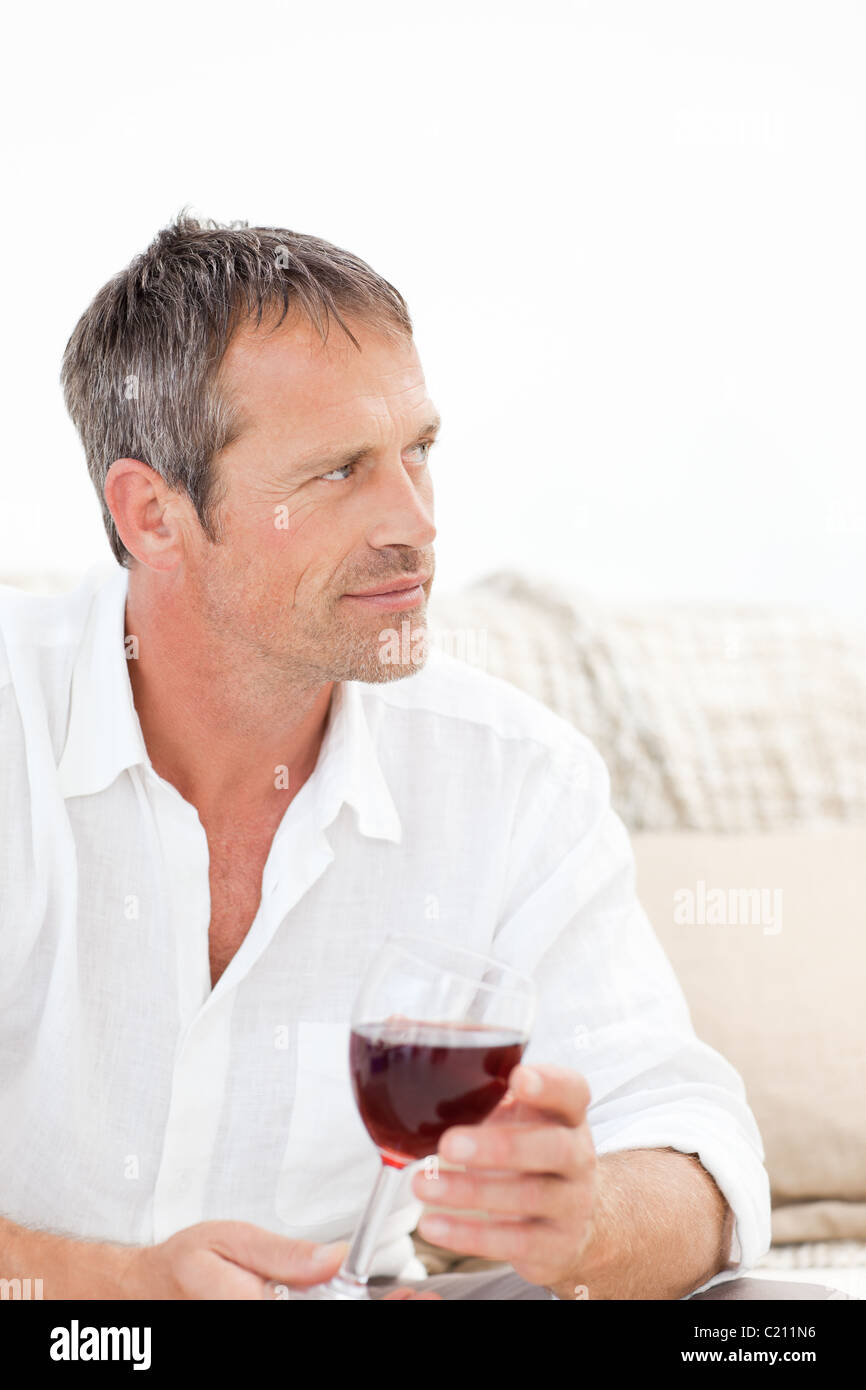 Handsome man drinking some red wine Stock Photo - Alamy