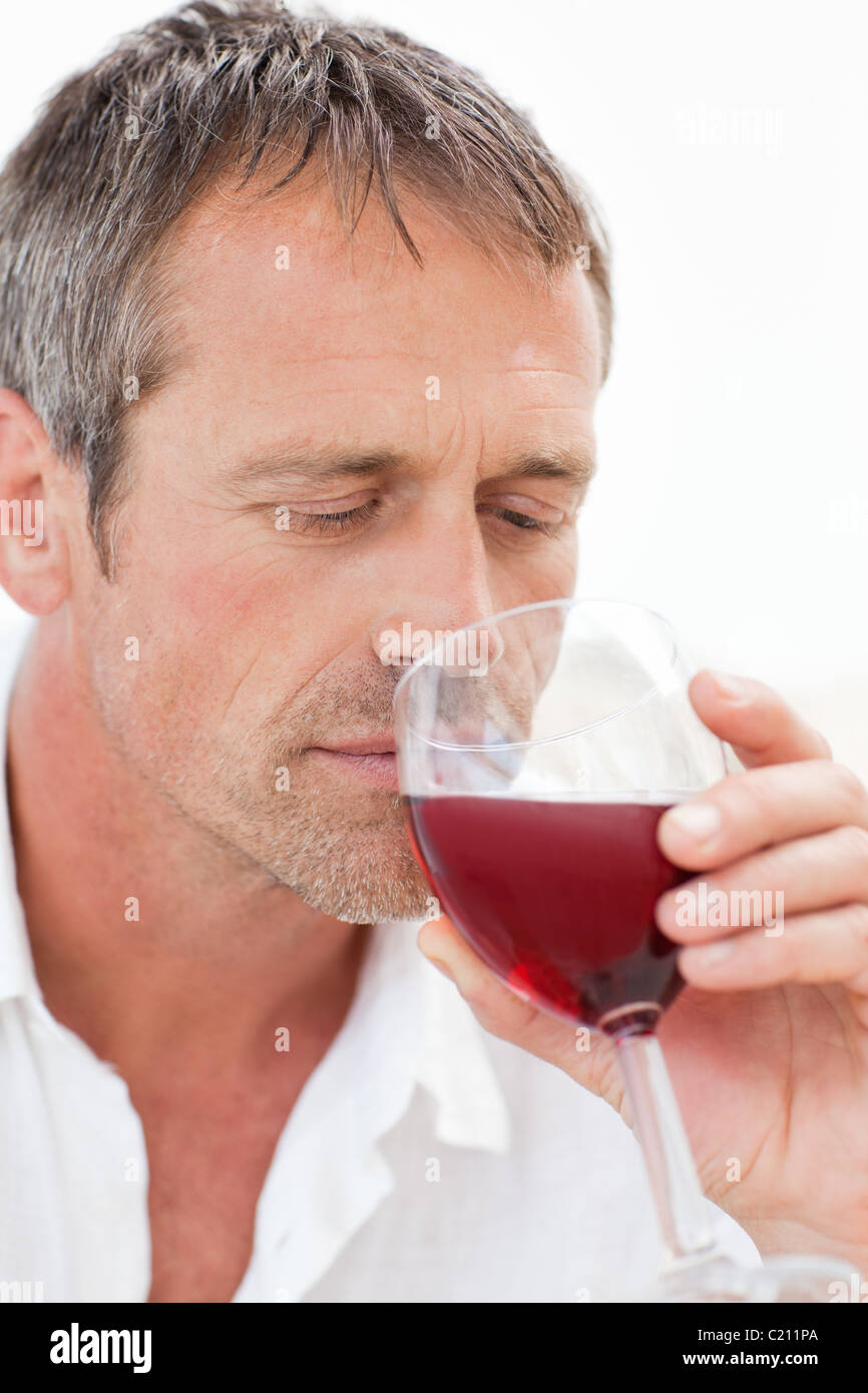 Handsome man drinking some red wine Stock Photo - Alamy