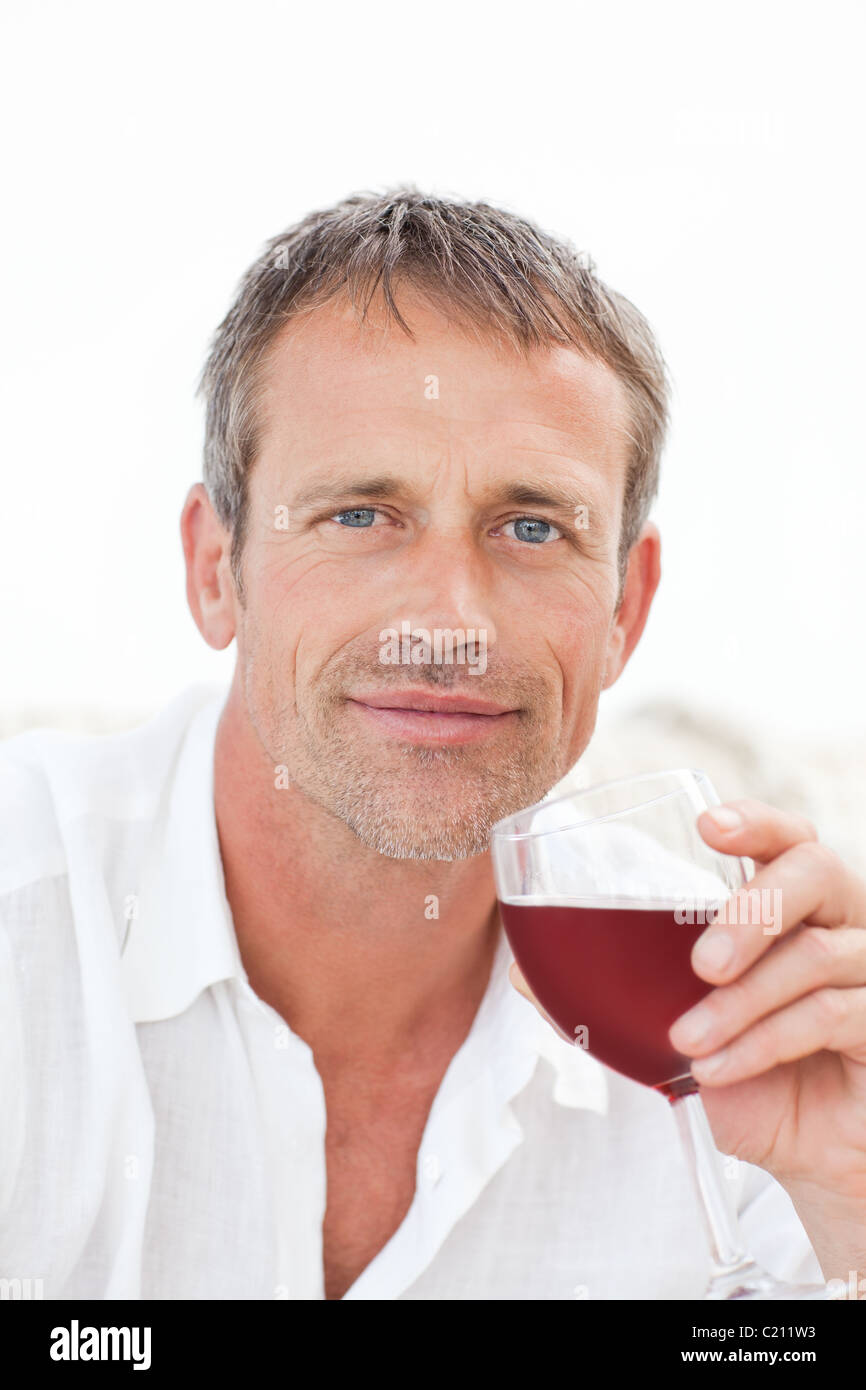 Handsome man drinking some red wine Stock Photo - Alamy