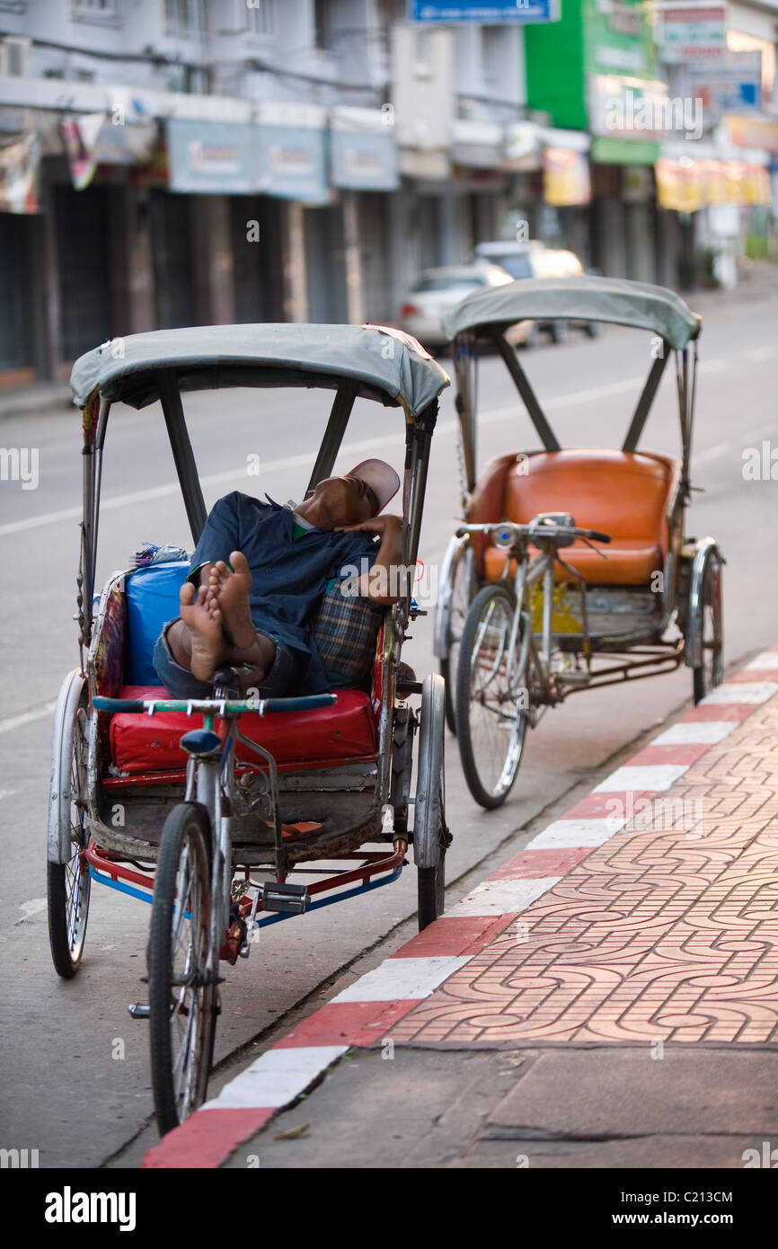 Saamlaw (three wheeled pedicab) driver at sleep on his bike. Surin ...