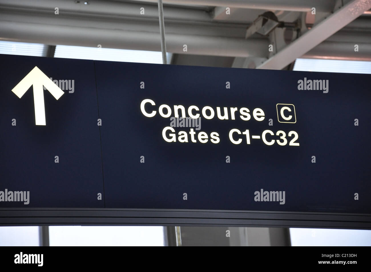 a dark blue airport sign reading Concourse C and Gates C1 to C32 in ...