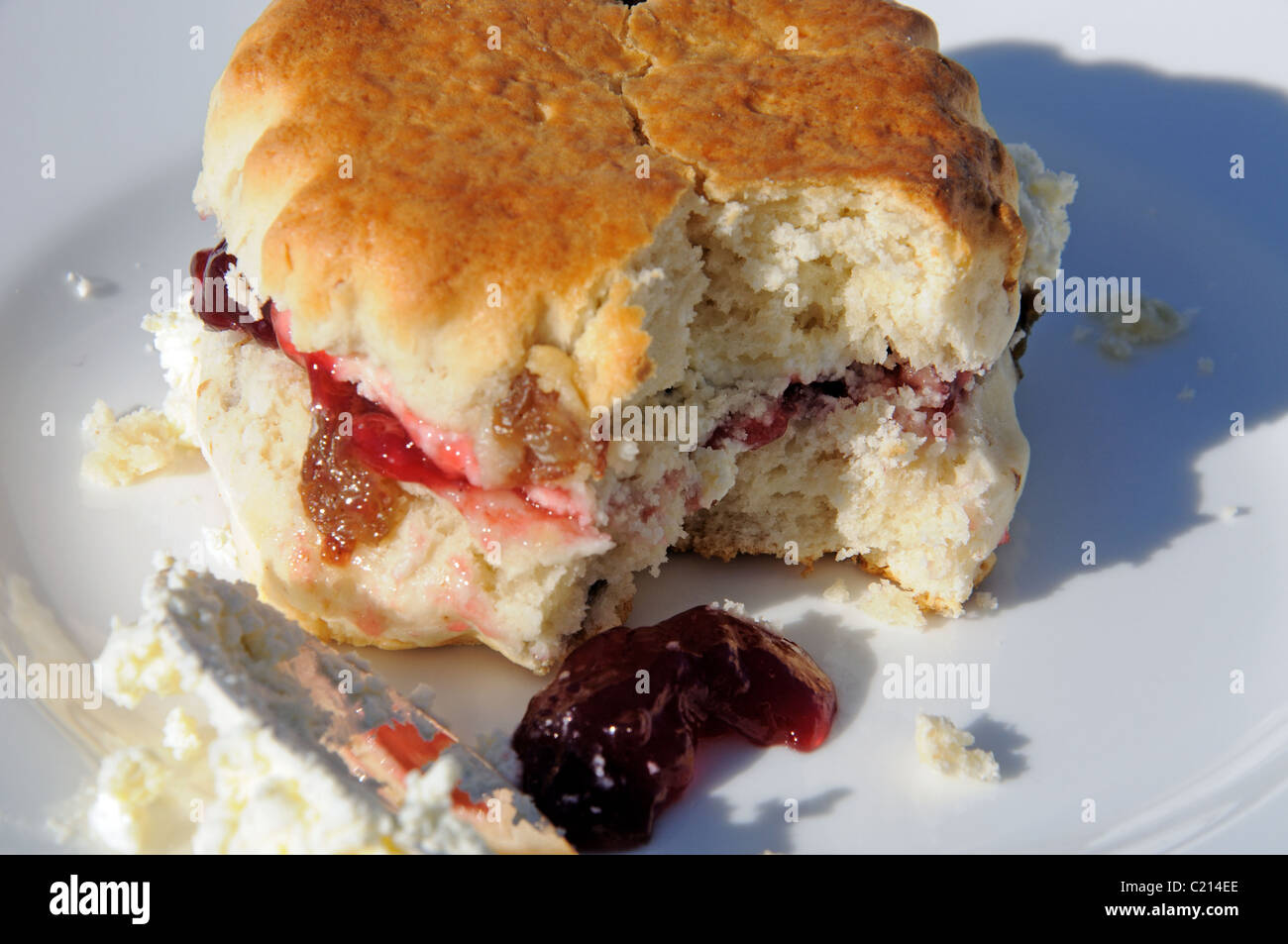 Scone with strawberry jam and clotted cream Stock Photo - Alamy