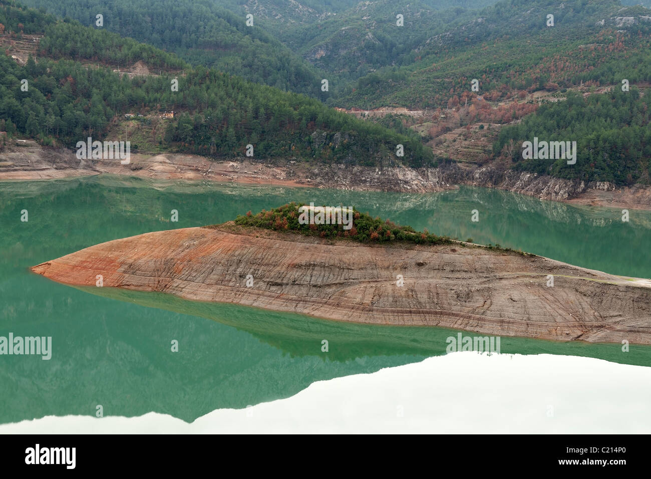 Form an island in the azure mountain lake Stock Photo - Alamy