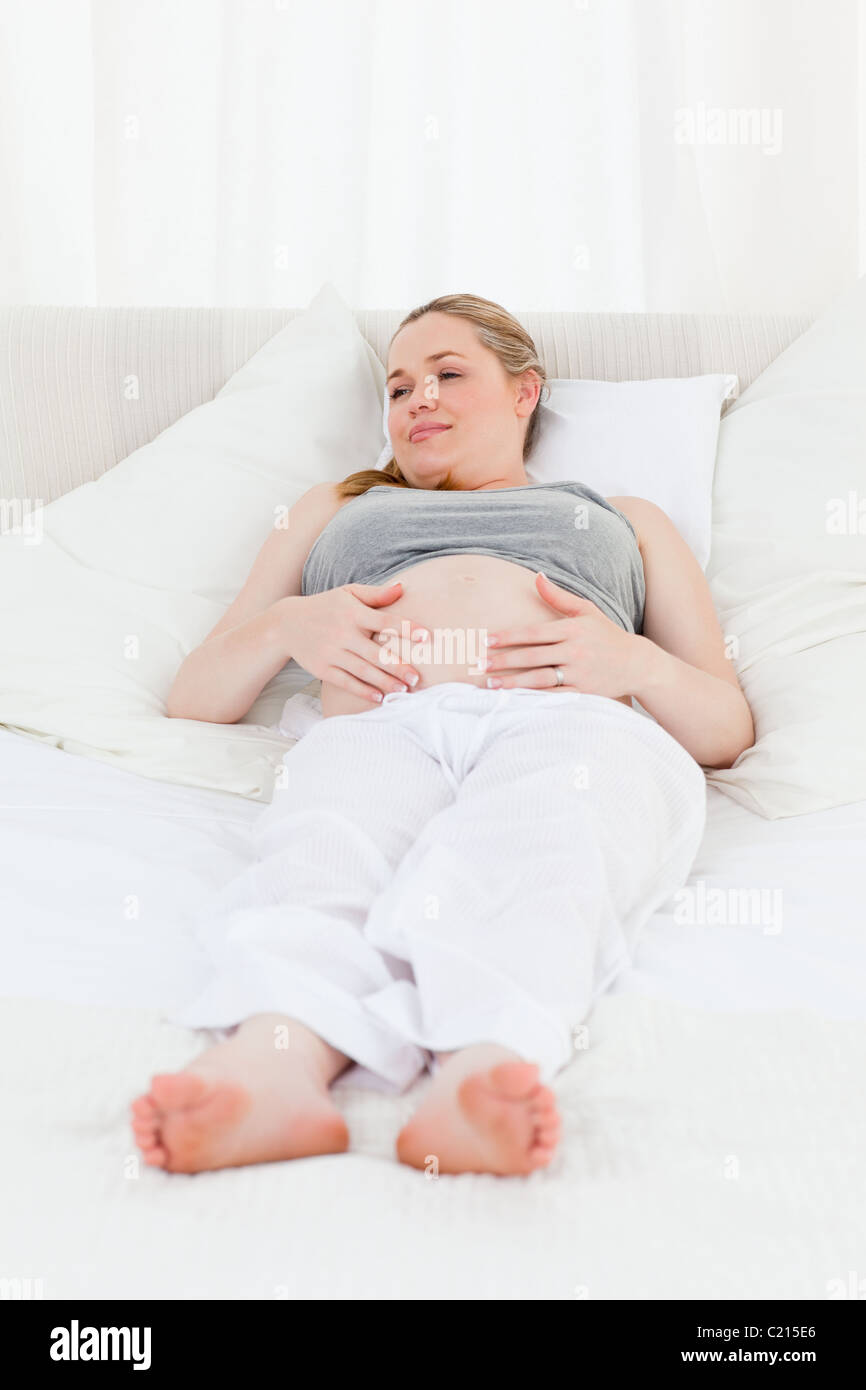 Beautiful woman with her hands on her belly Stock Photo - Alamy