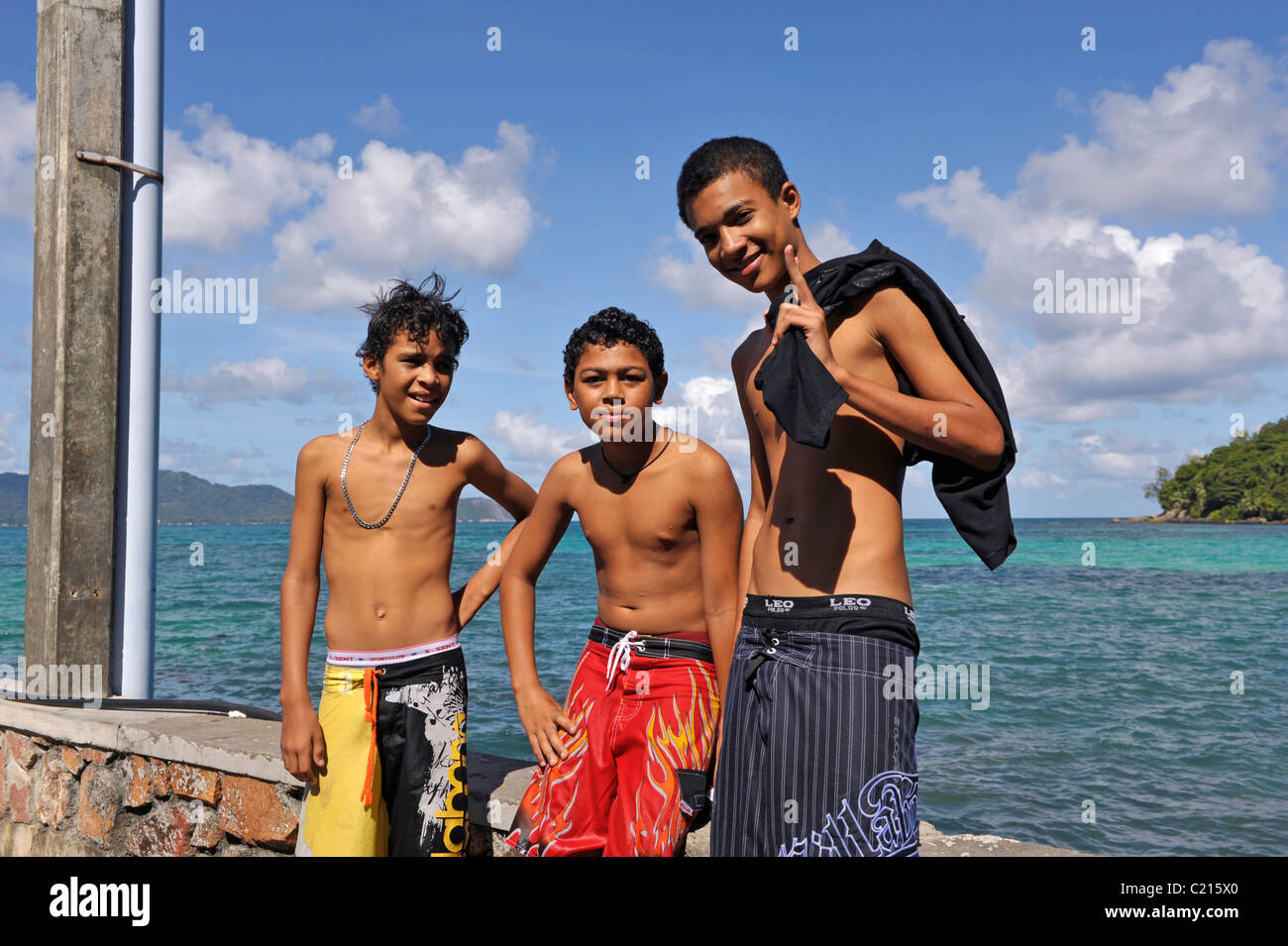 Three dark skinned teenagers, Praslin Island, Seychelles Stock Photo ...