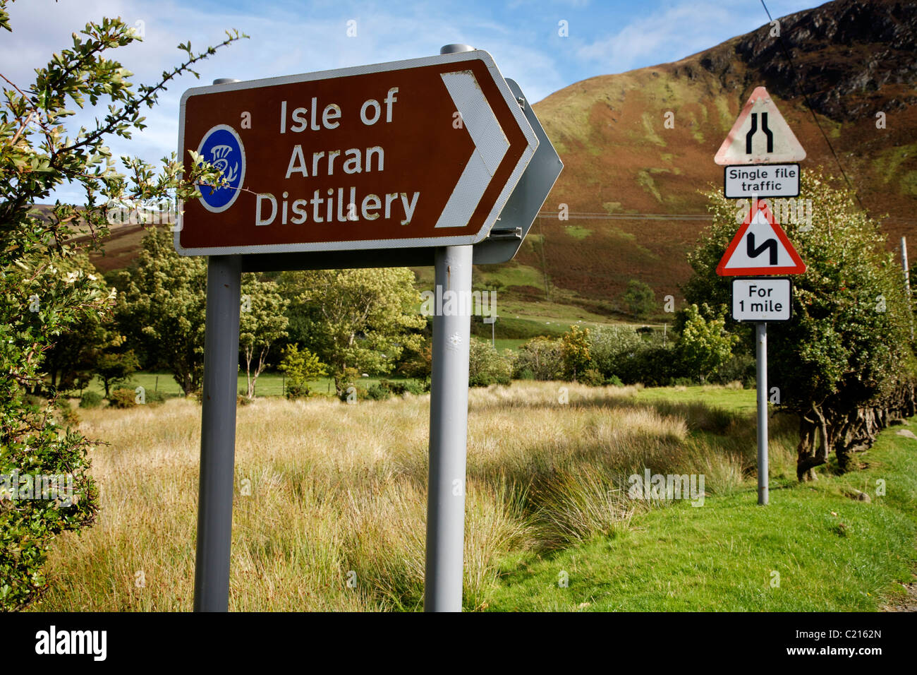 Sign pointing the way to the Isle of Arran Distillery with road signs ...
