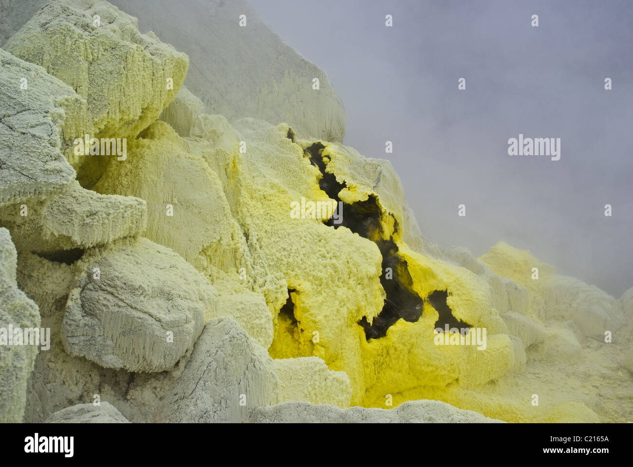 Sulfur lace and melted sulfur in a fumarole inside a crater of volcano ...