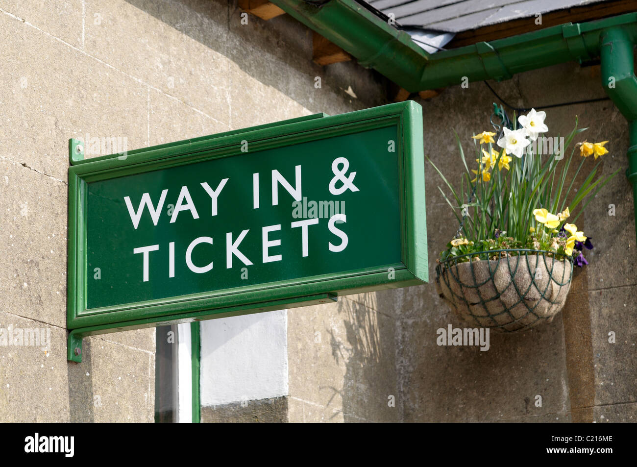 Railway station sign pointing to entrance and tickets Stock Photo - Alamy