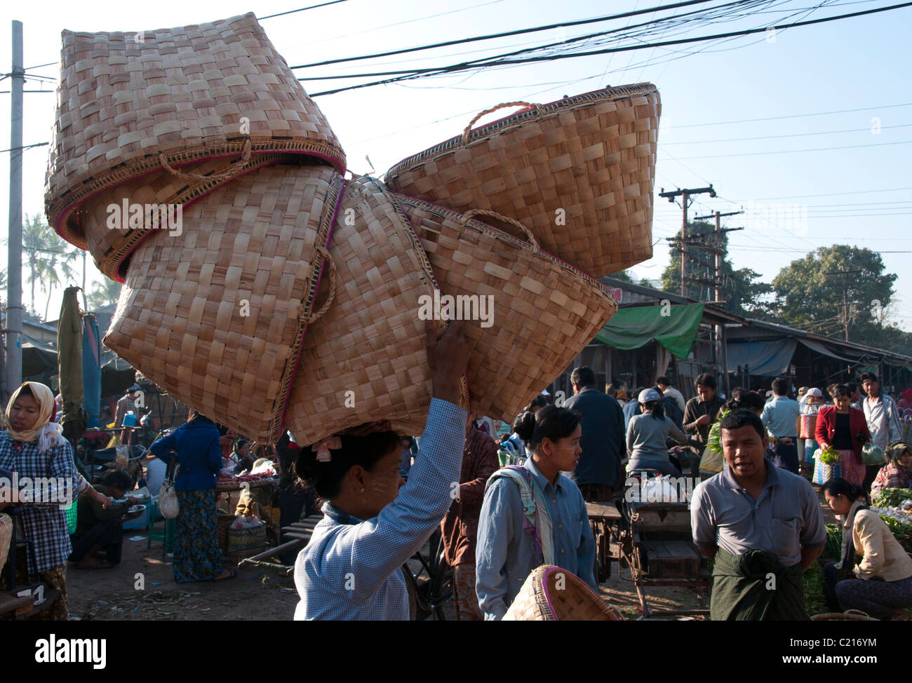 woman carrying bamboo baskets on her head. Zeigyio Market. Mandalay ...