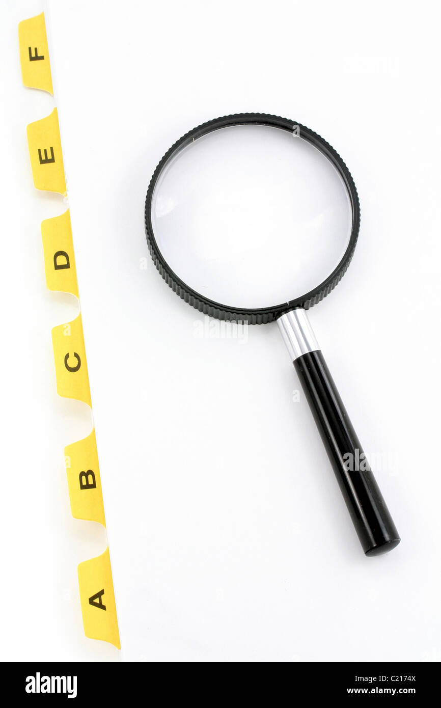 yellow file divider and magnifier, office supplies, close up Stock ...