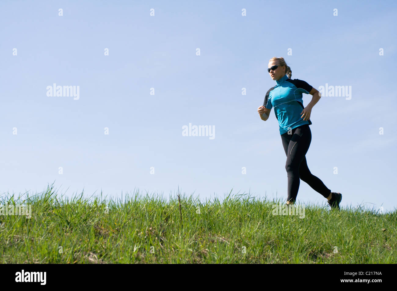 Young woman running to stay fit Stock Photo - Alamy